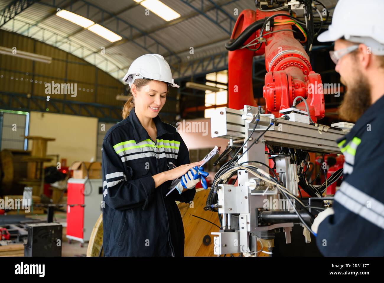 Mechanical engineers repairing engine machine at factory Stock Photo ...