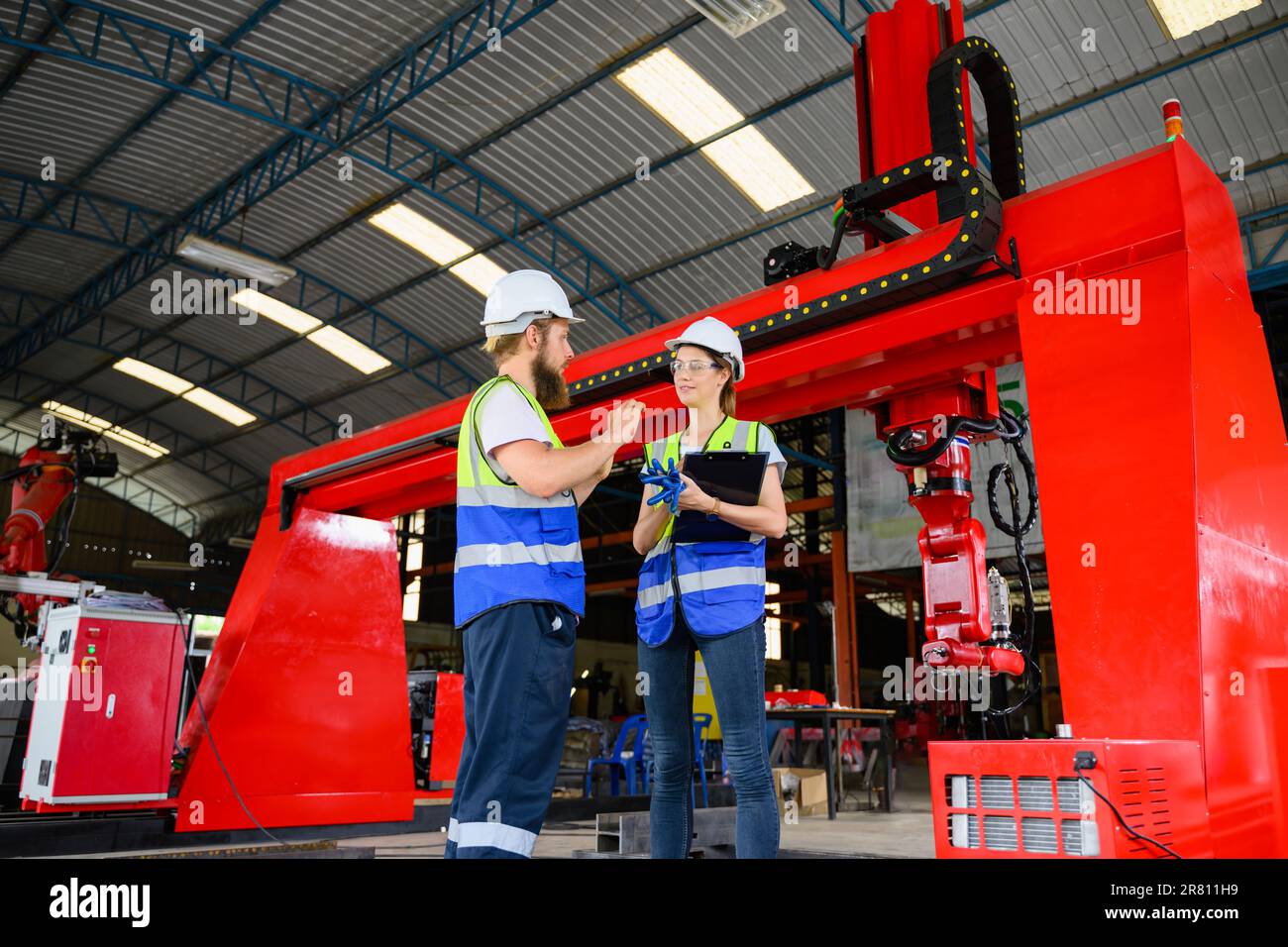 Mechanical engineers repairing engine machine at factory Stock Photo ...