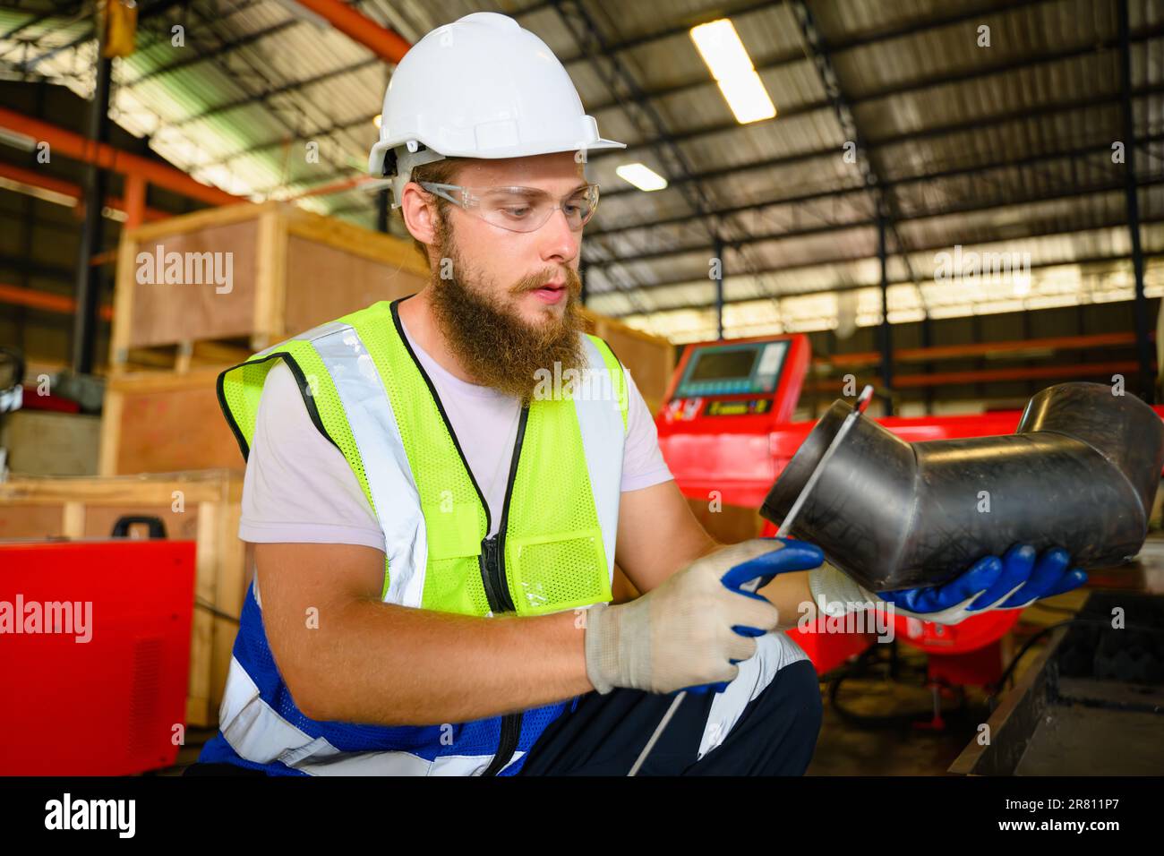 Mechanical engineers repairing engine machine at factory Stock Photo ...