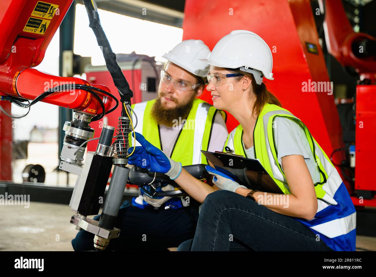 Mechanical engineers repairing engine machine at factory Stock Photo ...