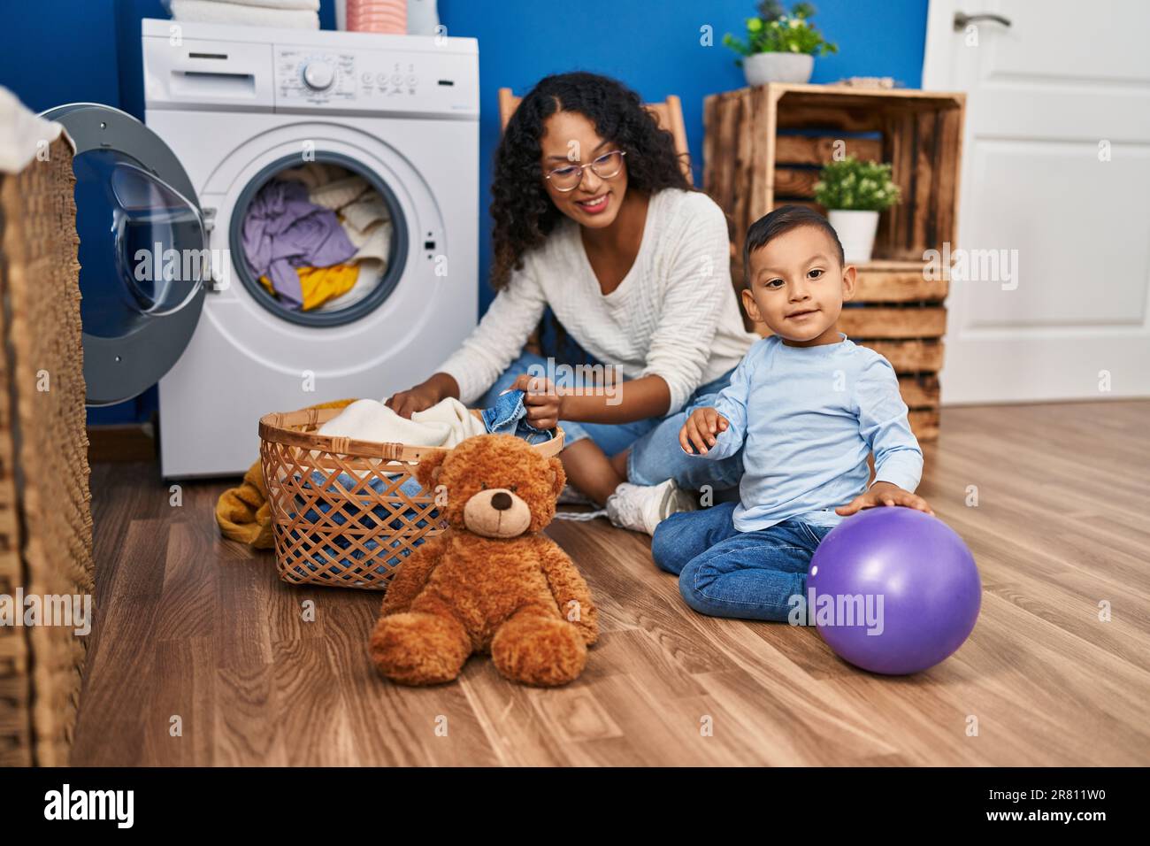 Mother and son smiling confident washing clothes at laundry room Stock ...