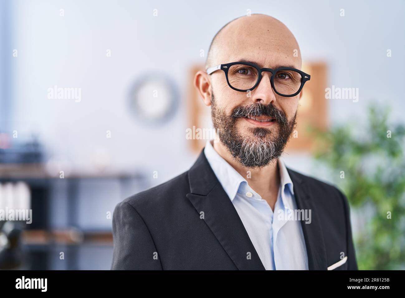 Young bald man business worker smiling confident at office Stock Photo ...