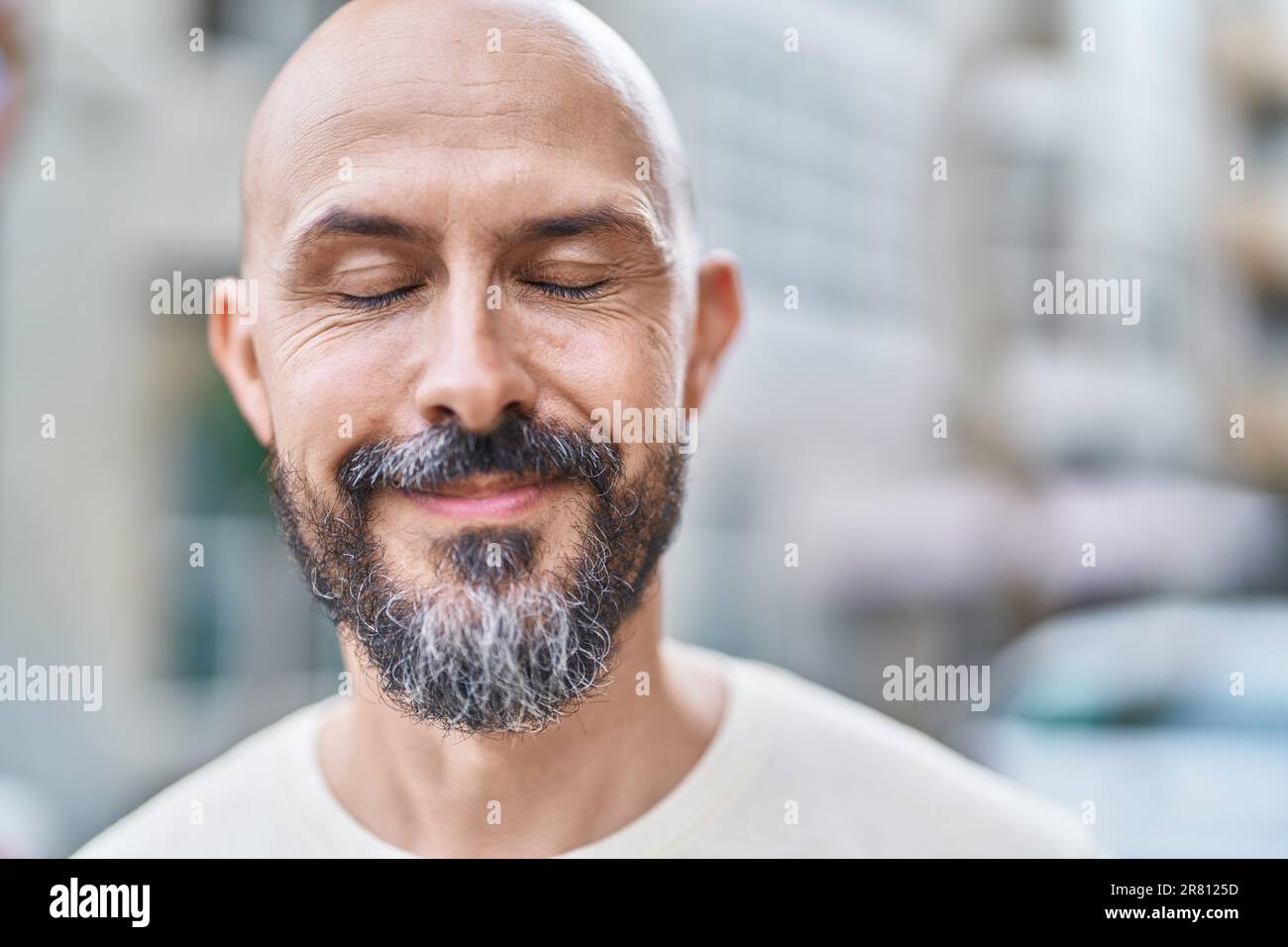 Young bald man smiling confident standing at street Stock Photo - Alamy