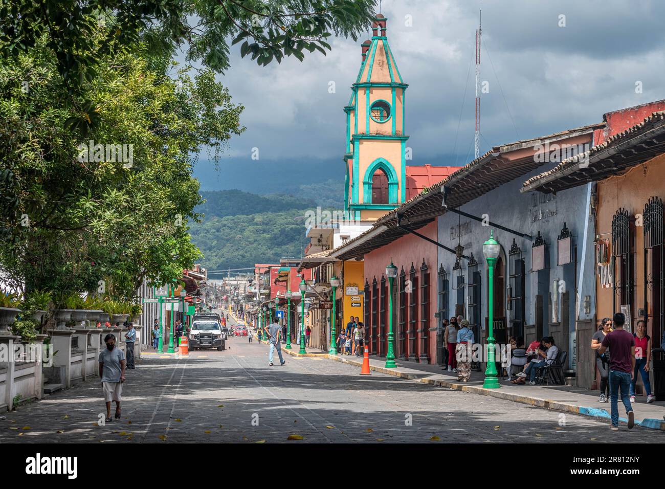 A vibrant bustling road surrounded by colorful buildings in Coatepec ...