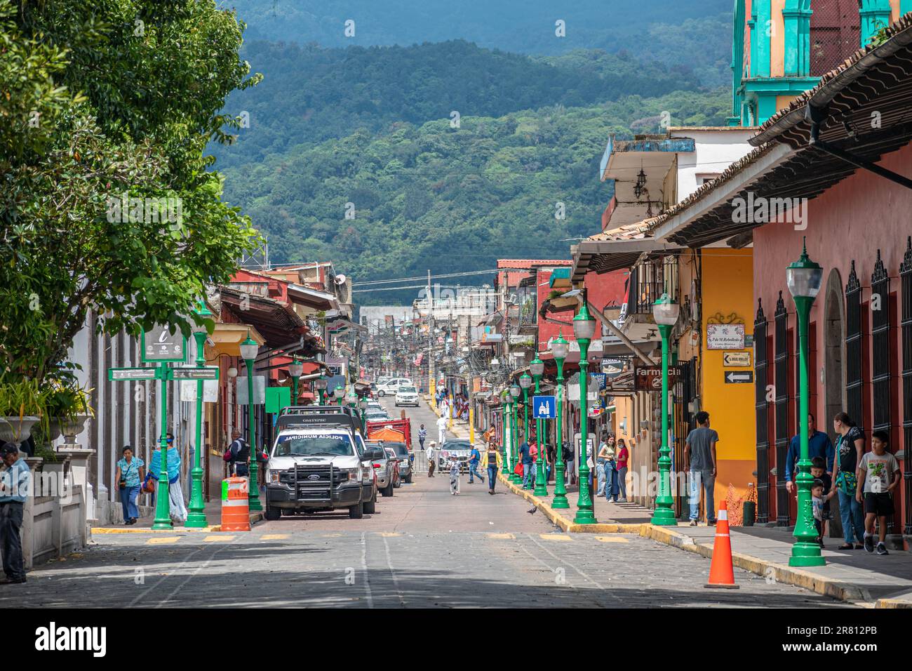 A vibrant bustling road surrounded by colorful buildings in Coatepec ...
