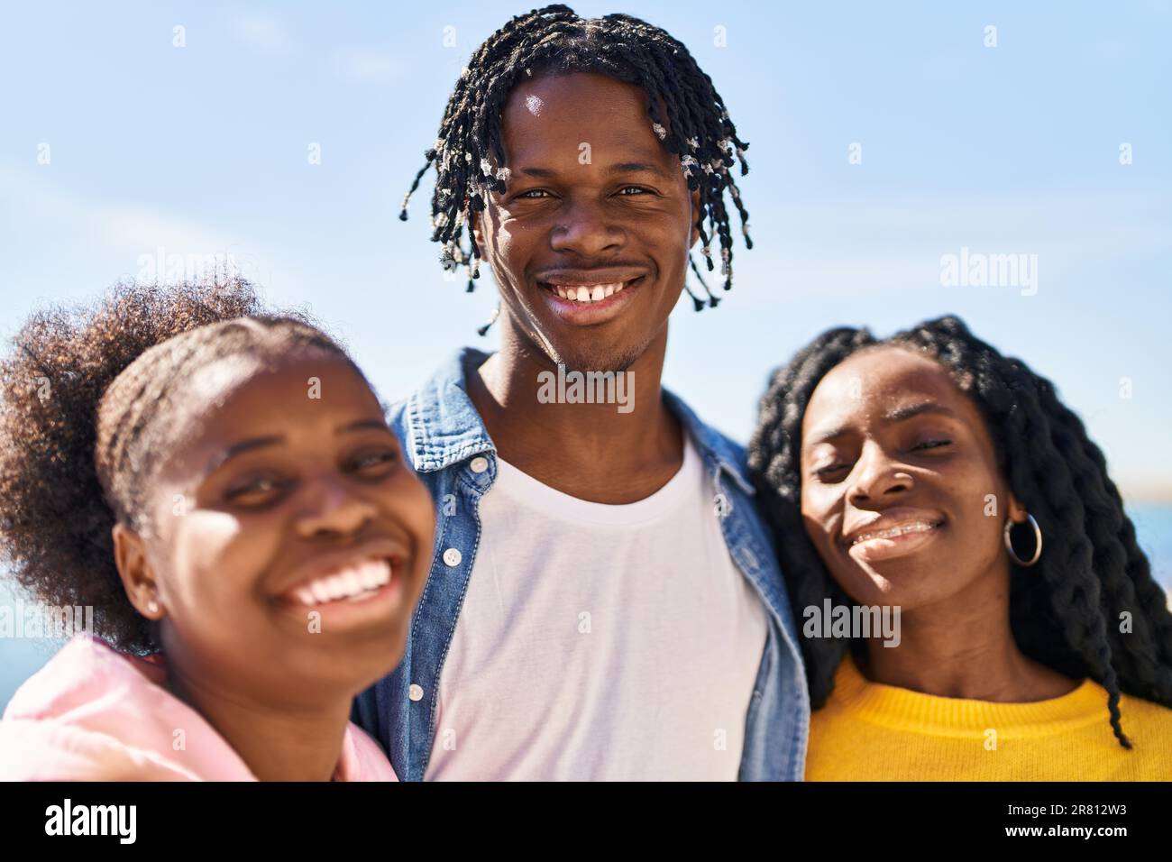 African american friends smiling confident standing together at seaside ...