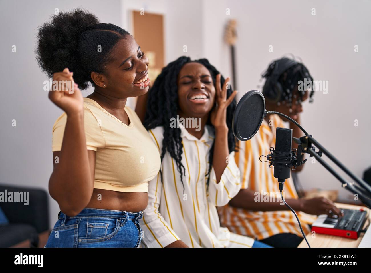 African american friends musicians group singing song at music studio ...