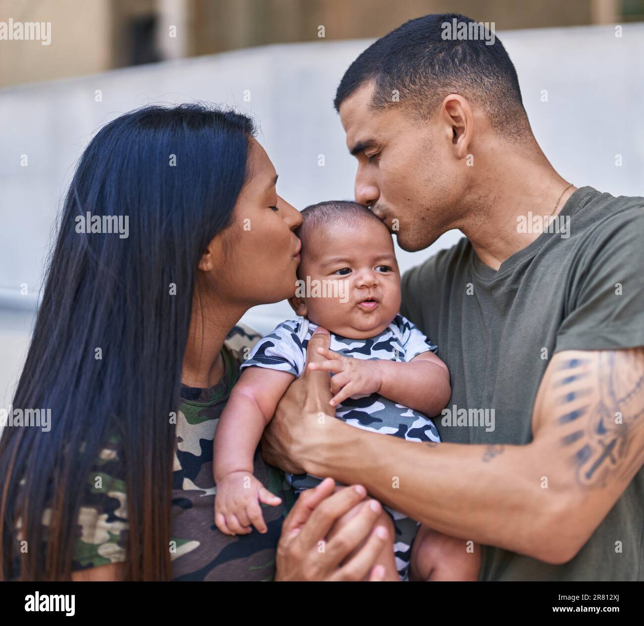 Hispanic family hugging each other and kissing at street Stock Photo ...