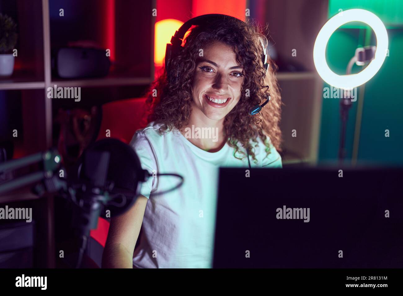 Young beautiful hispanic woman streamer playing video game using ...