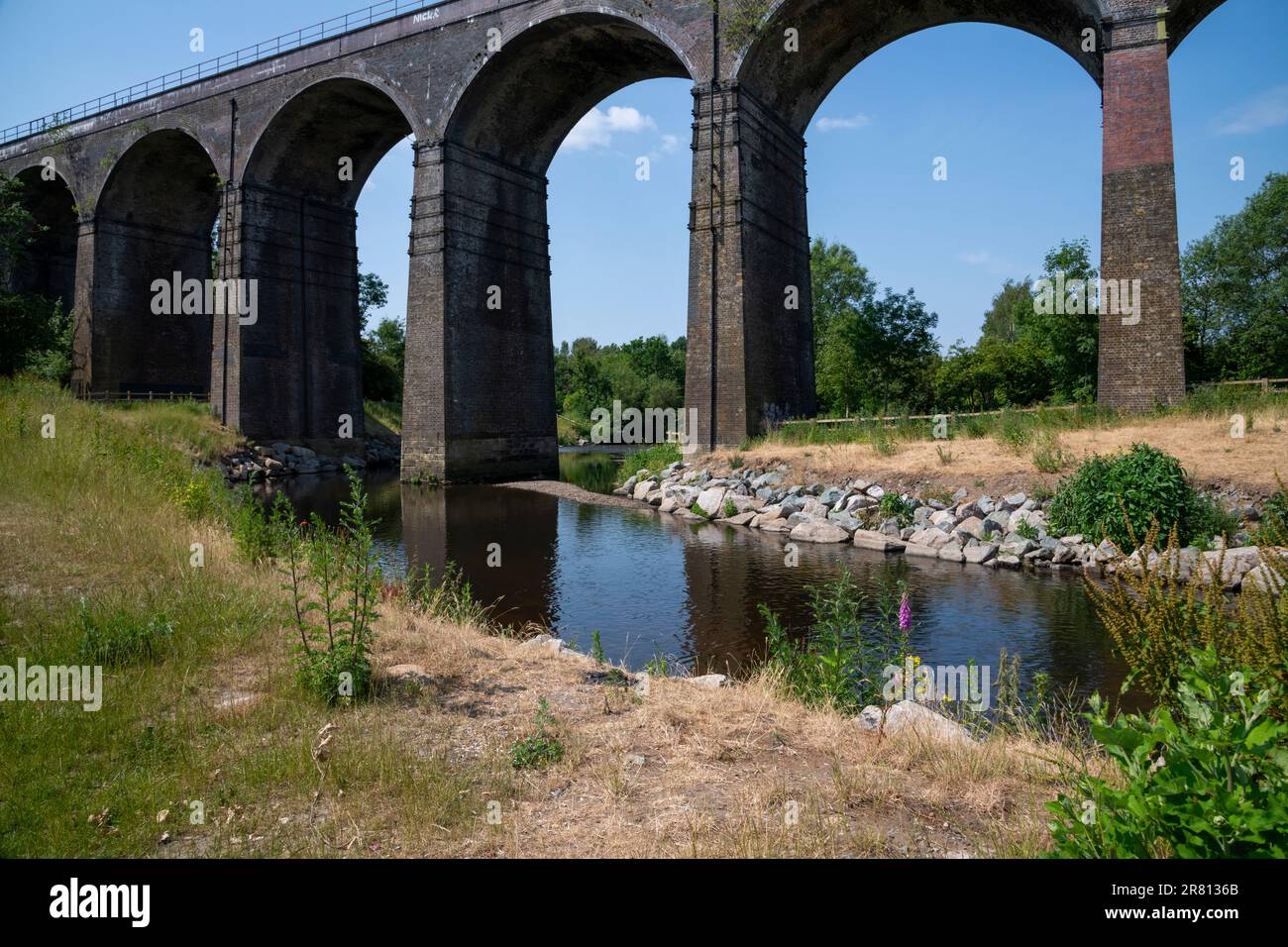 Railway viaduct over the river Tame at Reddish Vale country park ...