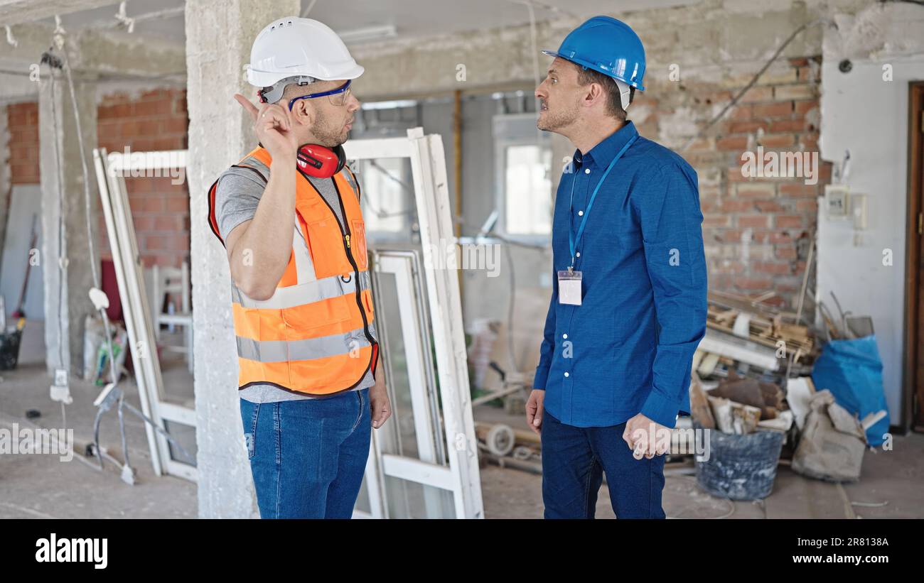 Two men builder and architect arguing at construction site Stock Photo ...