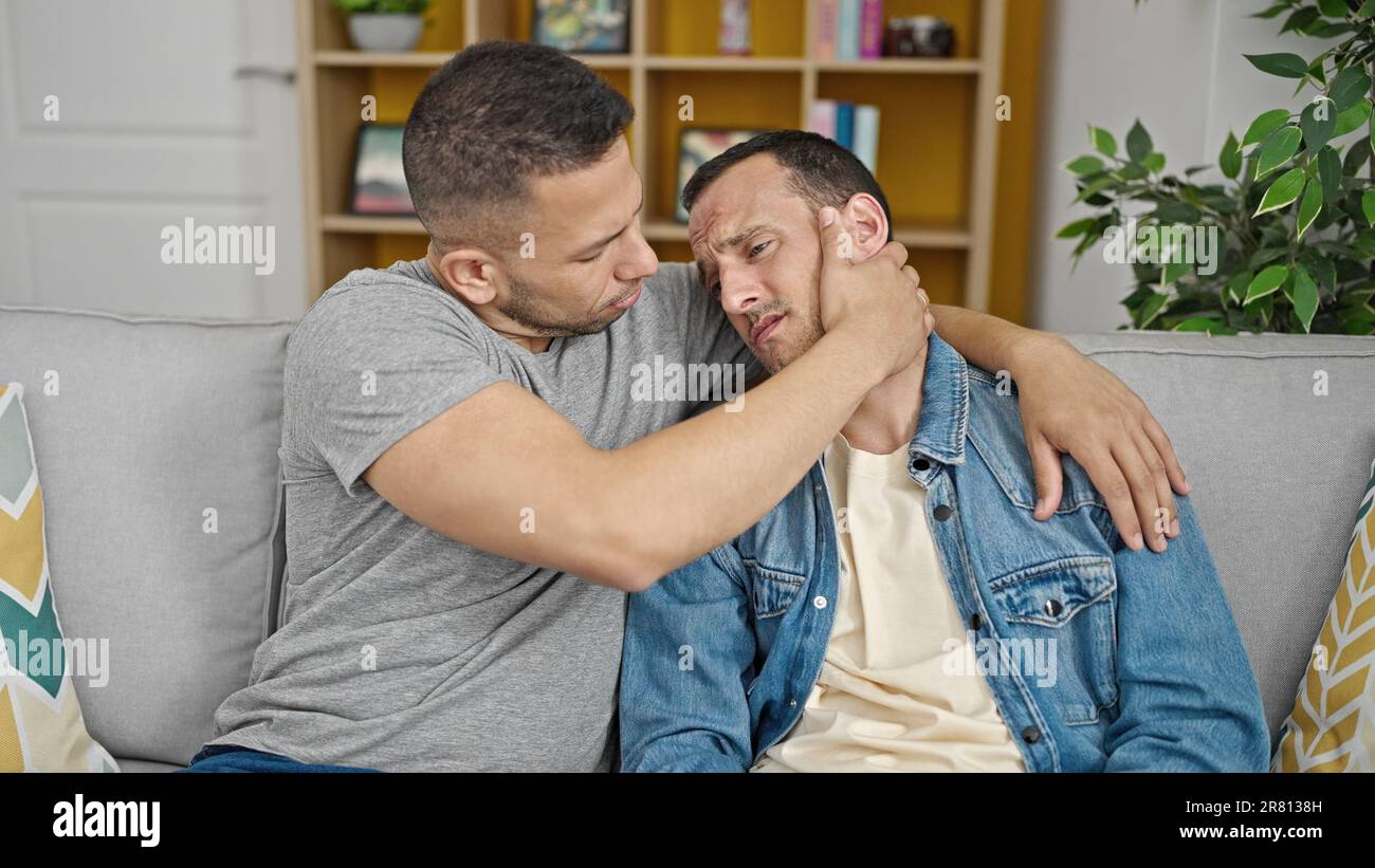 Two men couple hugging each other supporting at home Stock Photo - Alamy