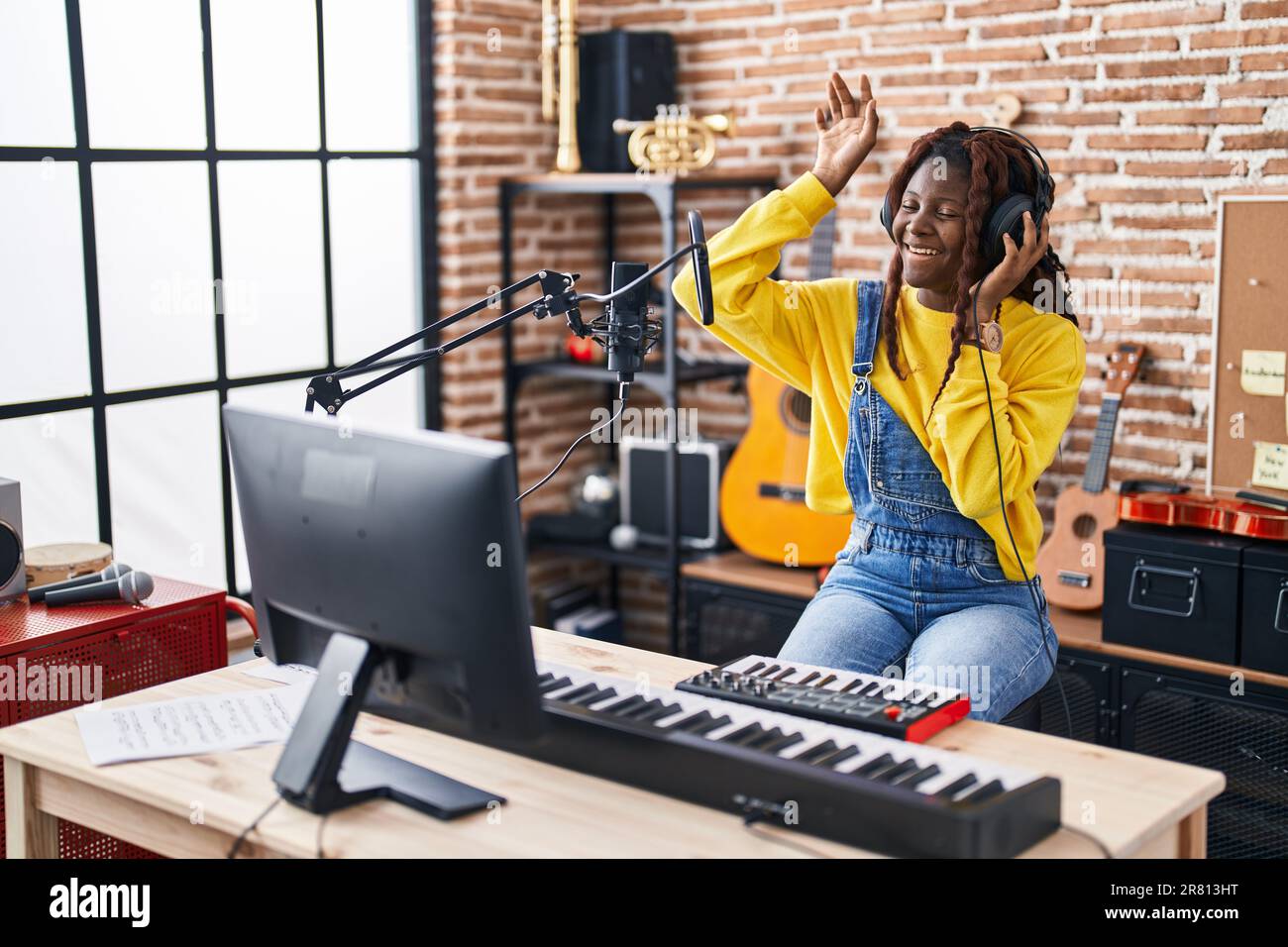 African american woman musician having dj session at music studio Stock ...