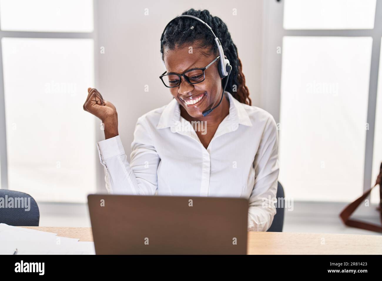 African woman with braided hair wearing call center agent headset ...