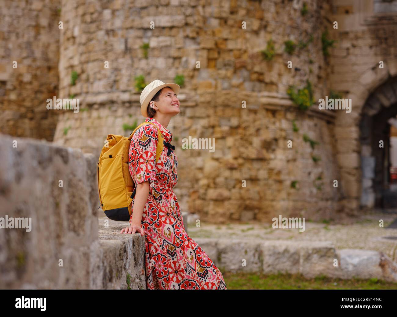 summer trip to Rhodes island, Greece. Young Asian woman in ethnic red ...