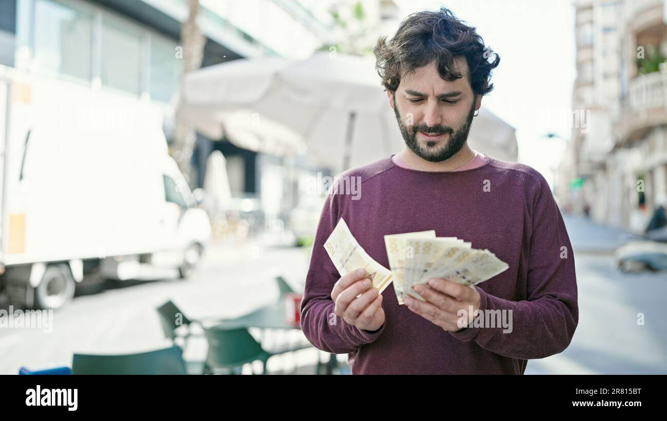 Young man standing outdoors counting hi-res stock photography and ...