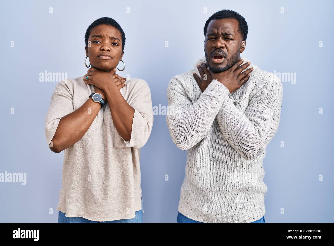 Young african american couple standing over blue background together ...
