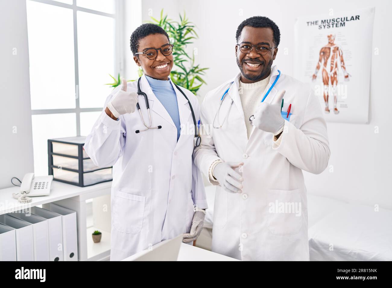 Young african american doctors working at medical clinic smiling happy ...