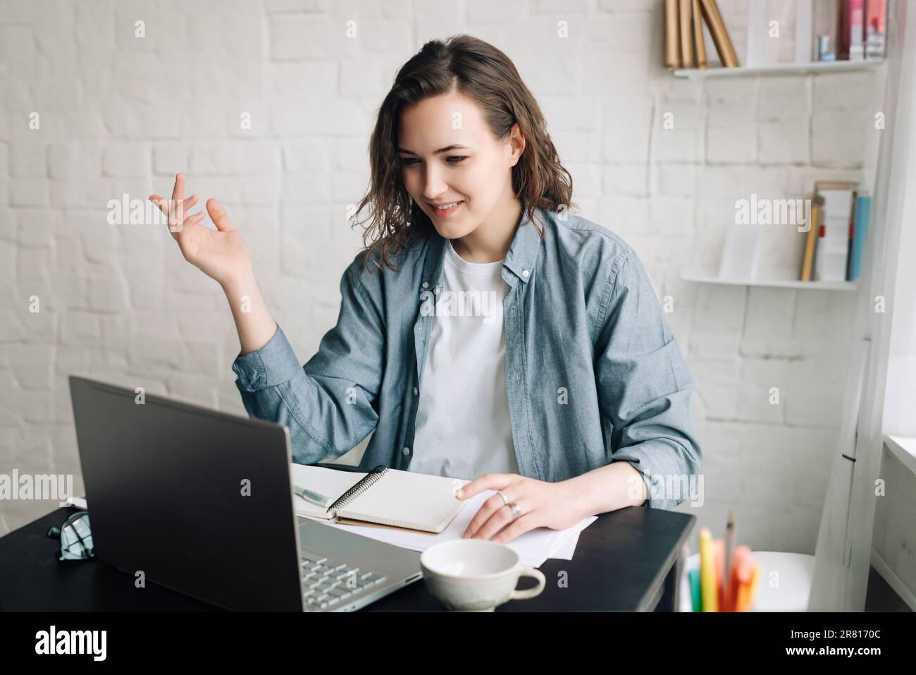 Confident businesswoman engaging in video conference from office ...