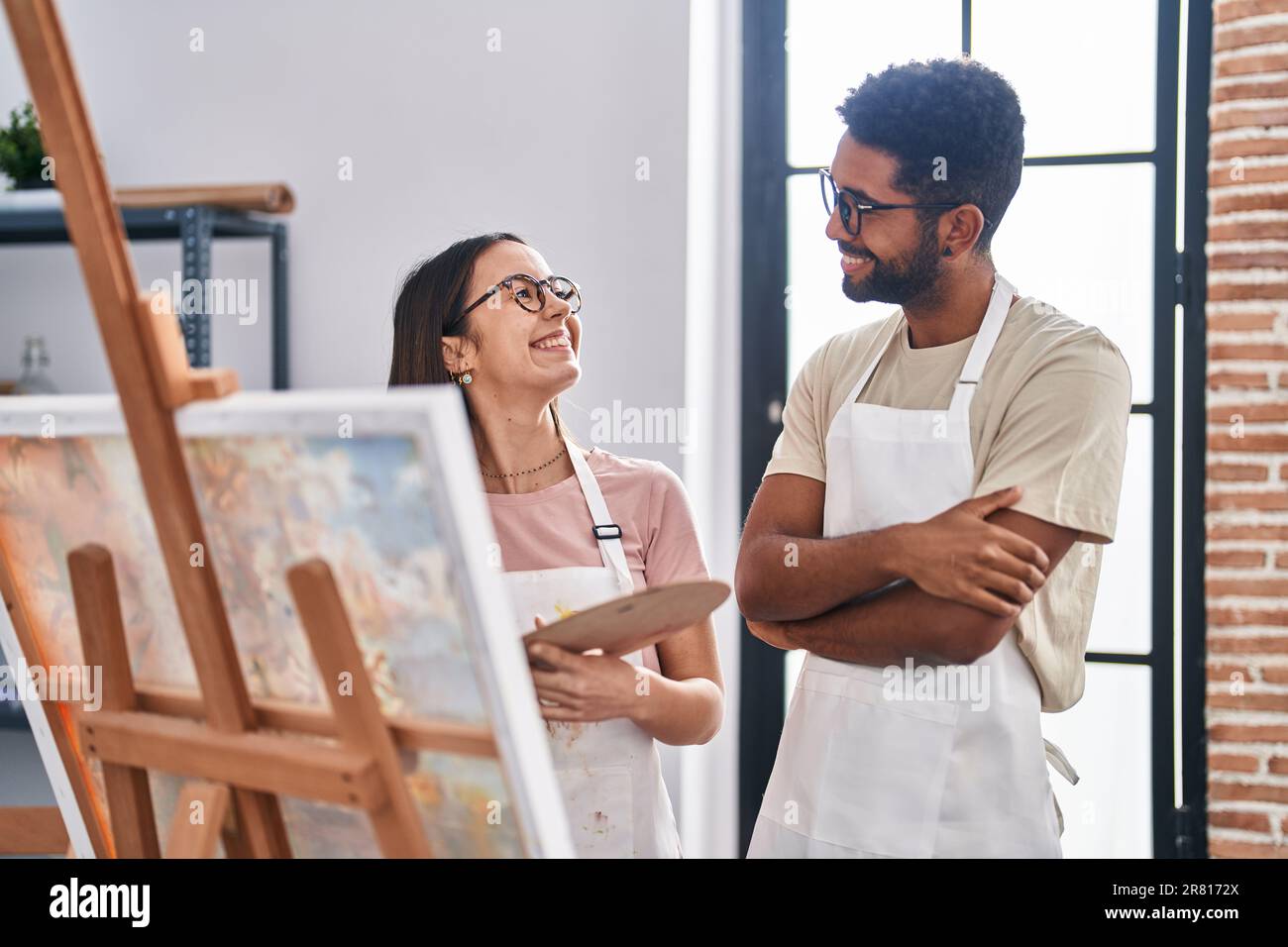 Man and woman artists smiling confident drawing at art studio Stock ...