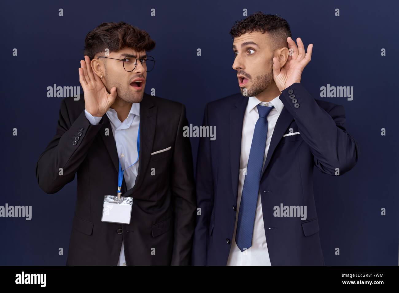 Two hispanic business men wearing business clothes smiling with hand ...
