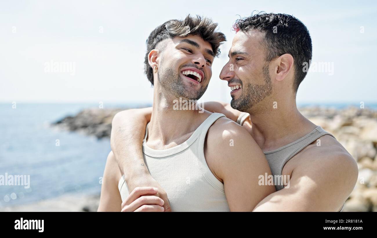 Two men couple smiling confident hugging each other at seaside Stock ...