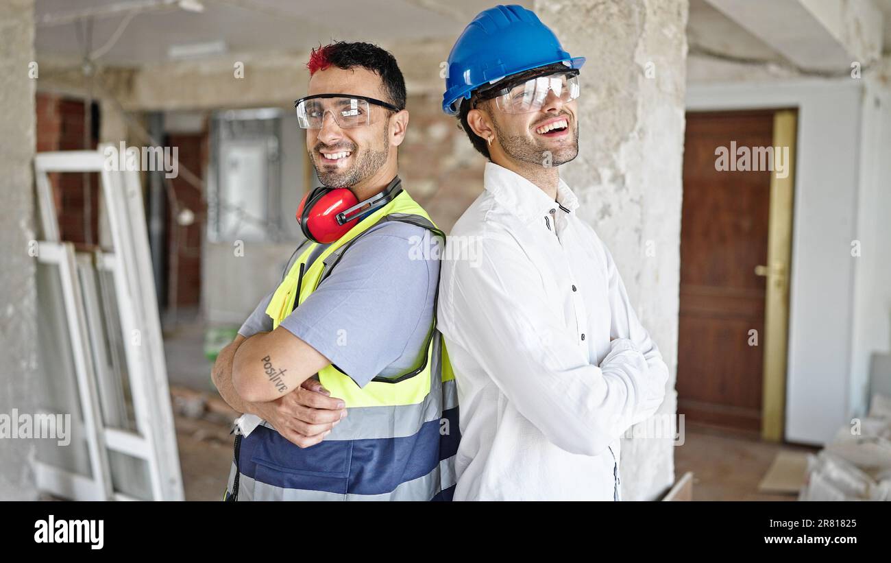 Two men builder and architect smiling confident standing with arms ...
