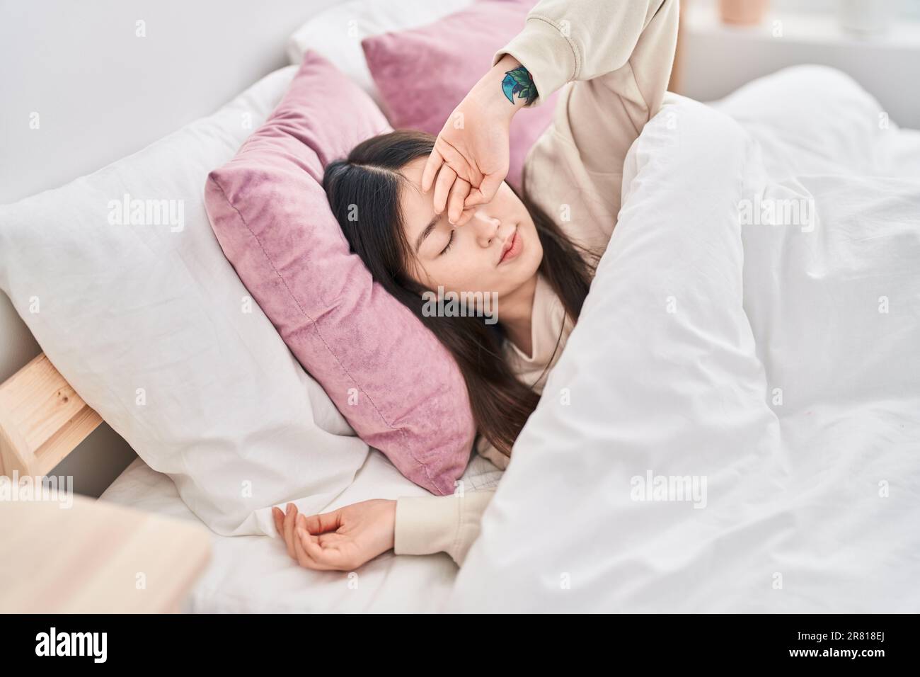 Chinese woman lying on bed sleeping at bedroom Stock Photo - Alamy
