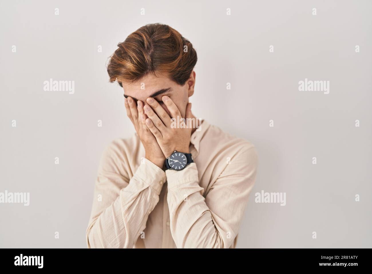 Young man standing over isolated background with sad expression ...
