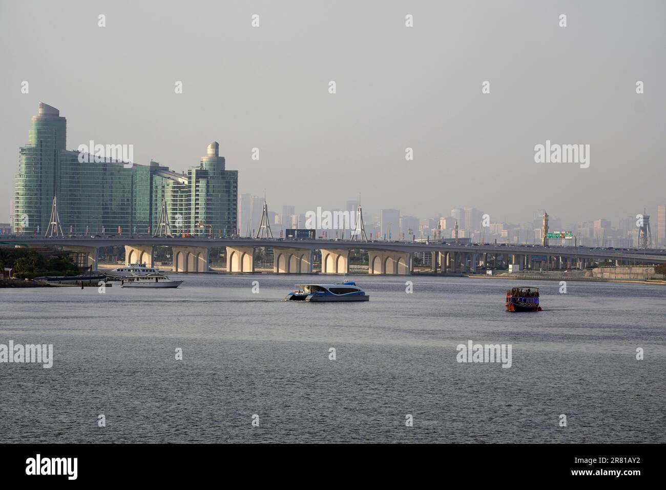 Boats crosses the creek waters in front of the Business Bay Crossing ...