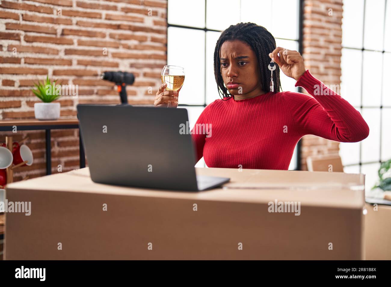 Young african american with braids showing keys of new home doing video ...