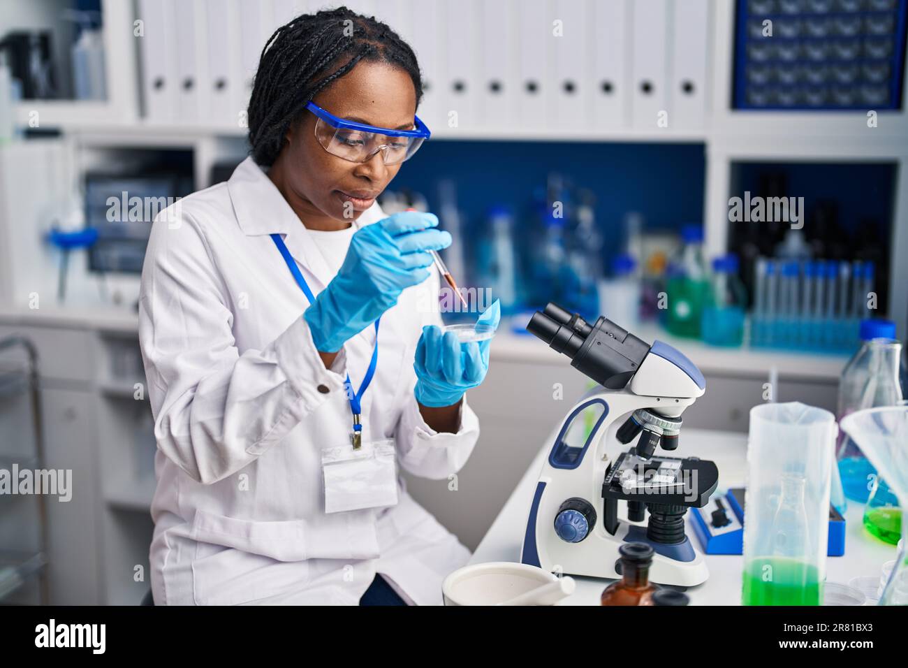 African american woman wearing scientist uniform working laboratory ...