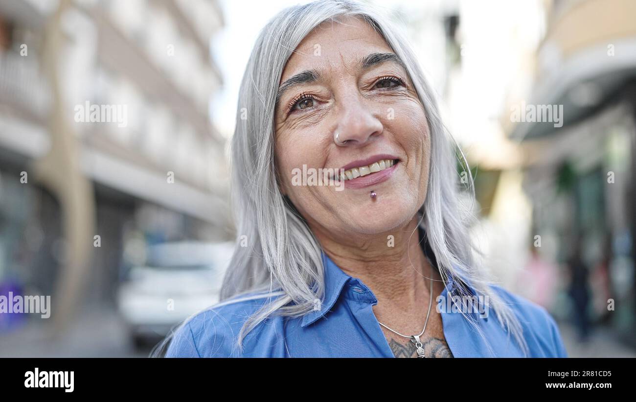 Middle age grey-haired woman smiling confident standing at street Stock ...