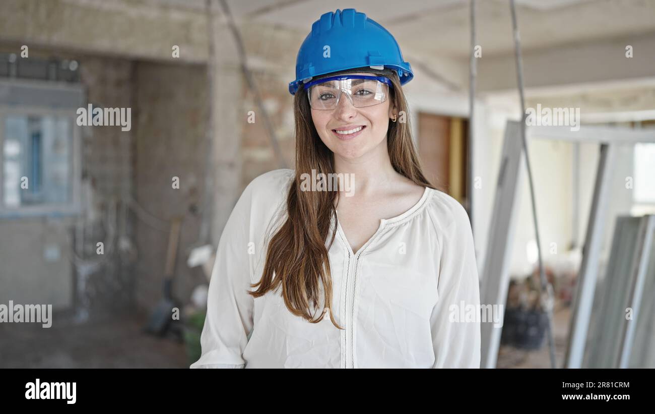 Young beautiful hispanic woman builder smiling confident wearing ...