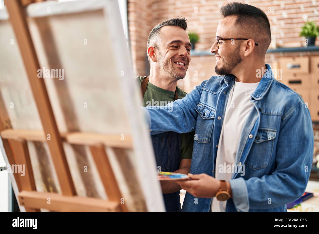 Two men artists smiling confident drawing at art studio Stock Photo - Alamy