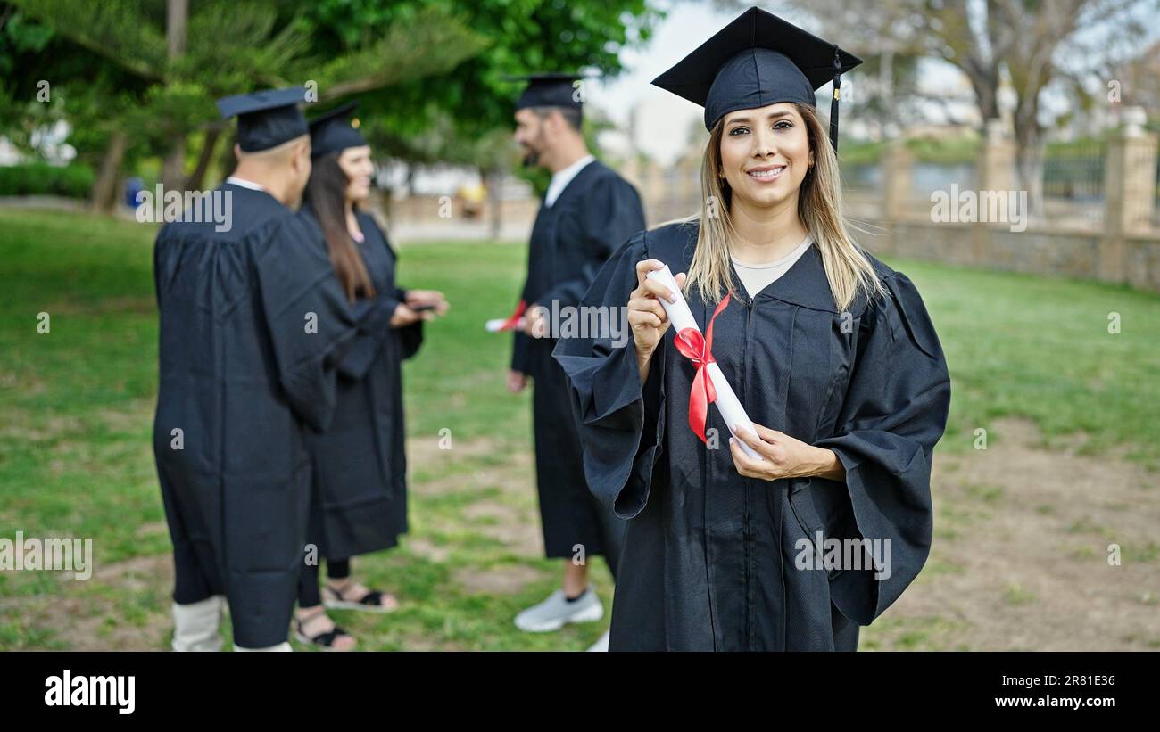 Group of people students graduated holding diploma at university campus ...