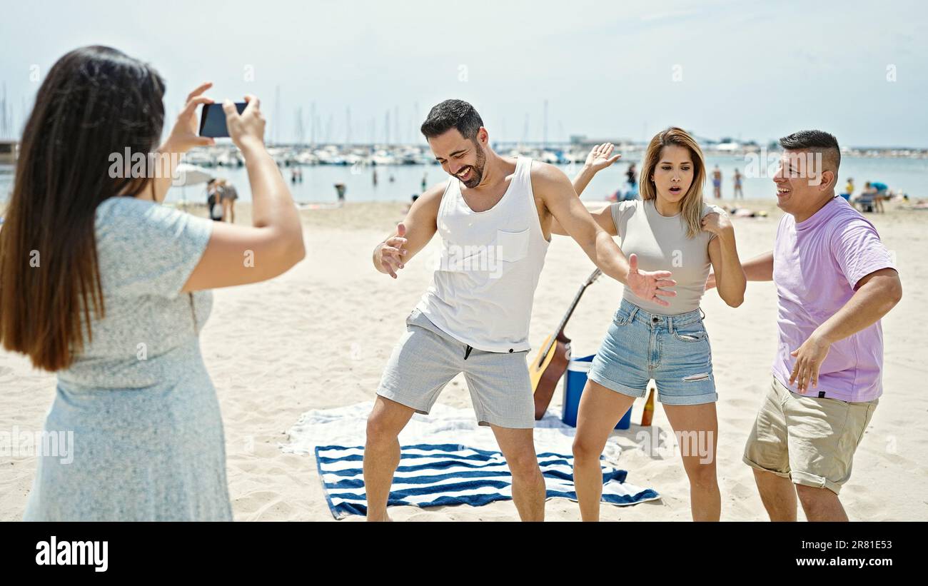 Group of people recording video by smartphone dancing at beach Stock ...