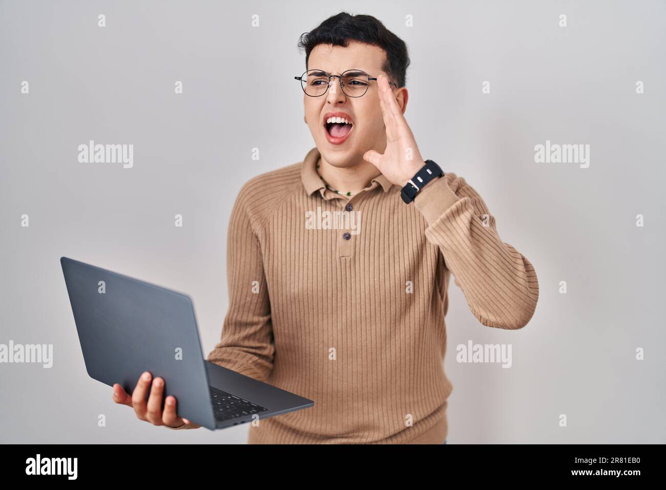 Non binary person using computer laptop shouting and screaming loud to ...