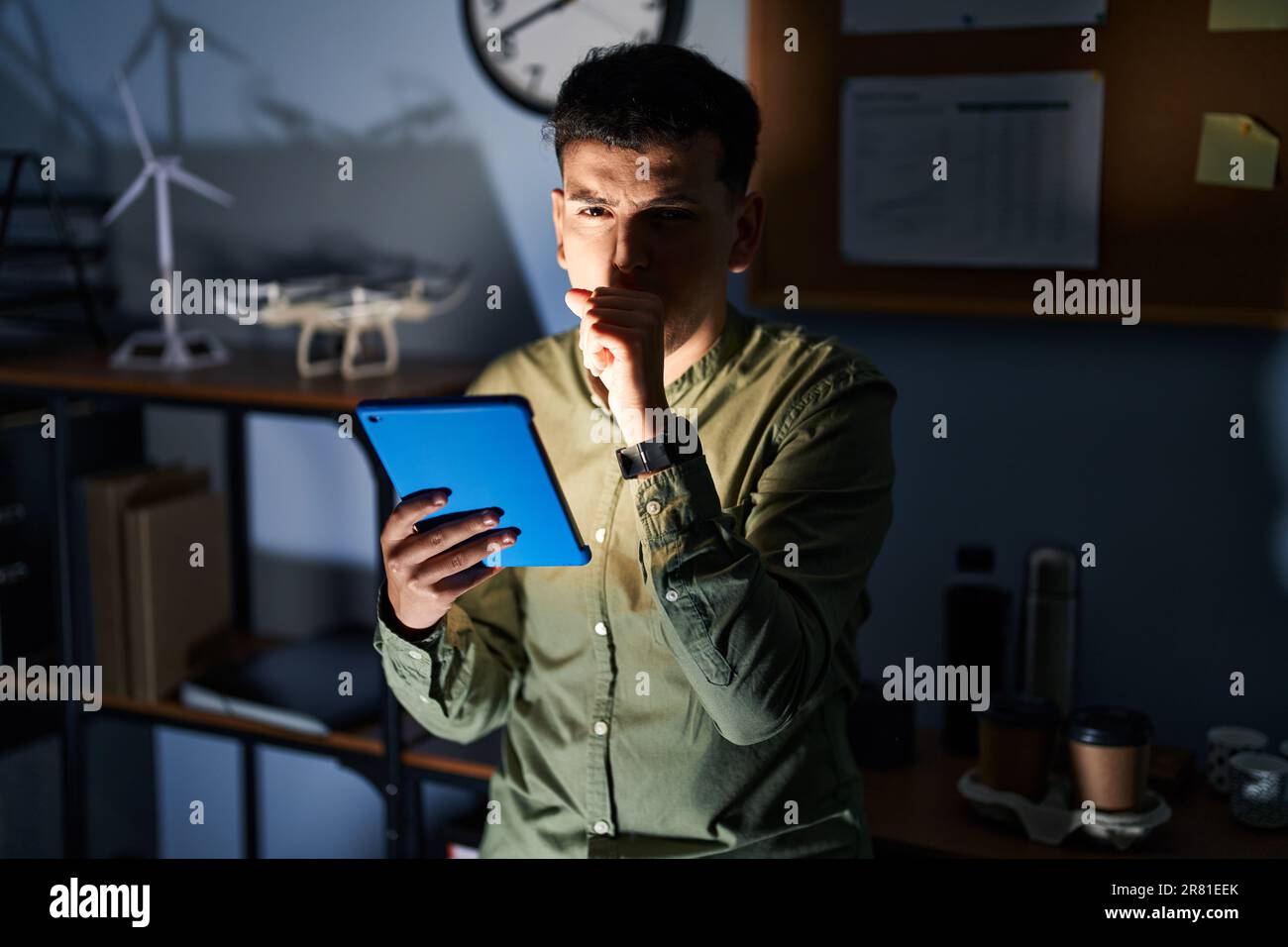 Non binary person using touchpad device at night feeling unwell and ...