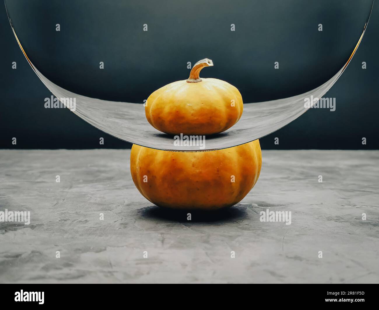 Unusual halloween-abstract picture with orange pumpkin on a concrete ...