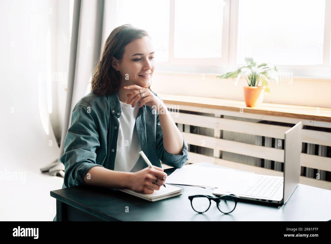 Young woman multitasking with laptop computer at office and student ...