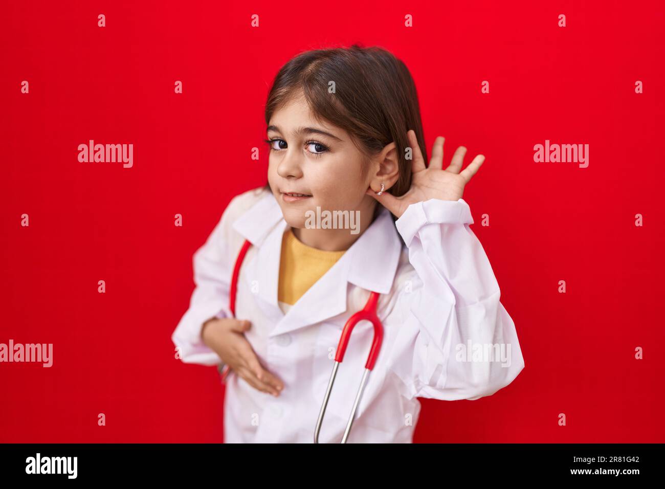 Little hispanic girl wearing doctor uniform and stethoscope smiling ...