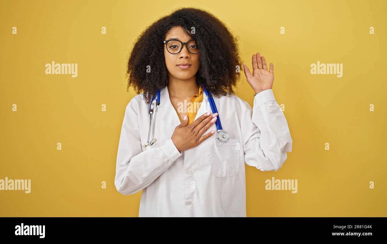 African american woman doctor making an oath with hand on chest over ...