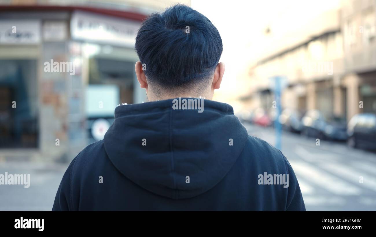Young chinese man standing on back view at street Stock Photo - Alamy