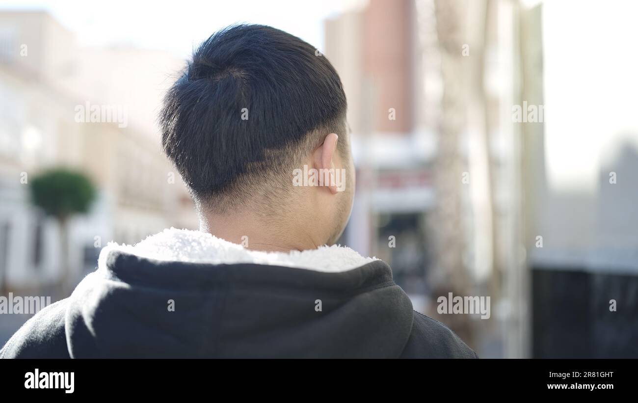 Young chinese man standing on back view at street Stock Photo - Alamy