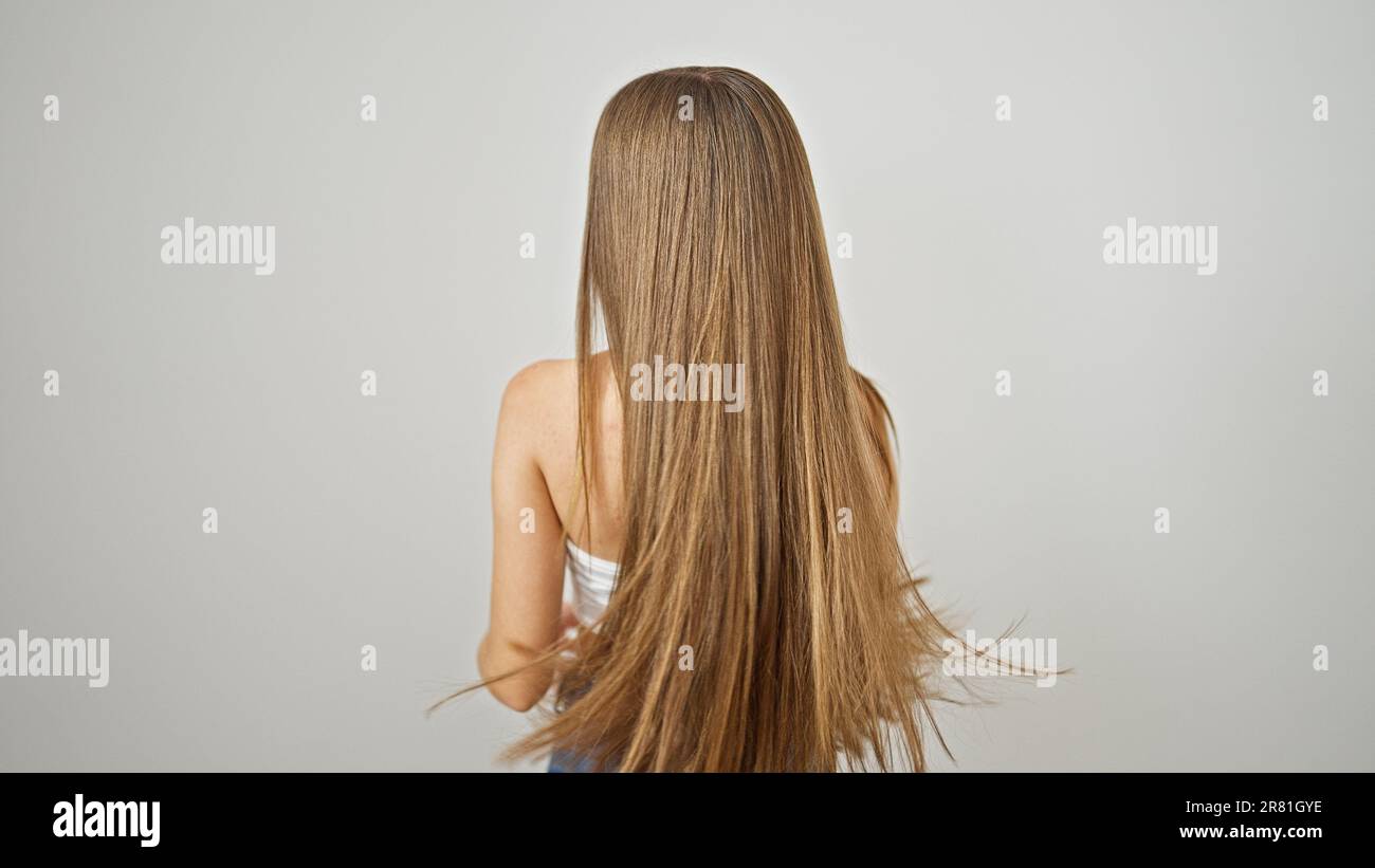 Young beautiful girl standing backwards over isolated white background ...