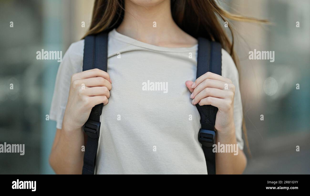 Young beautiful girl student wearing backpack standing at street Stock ...