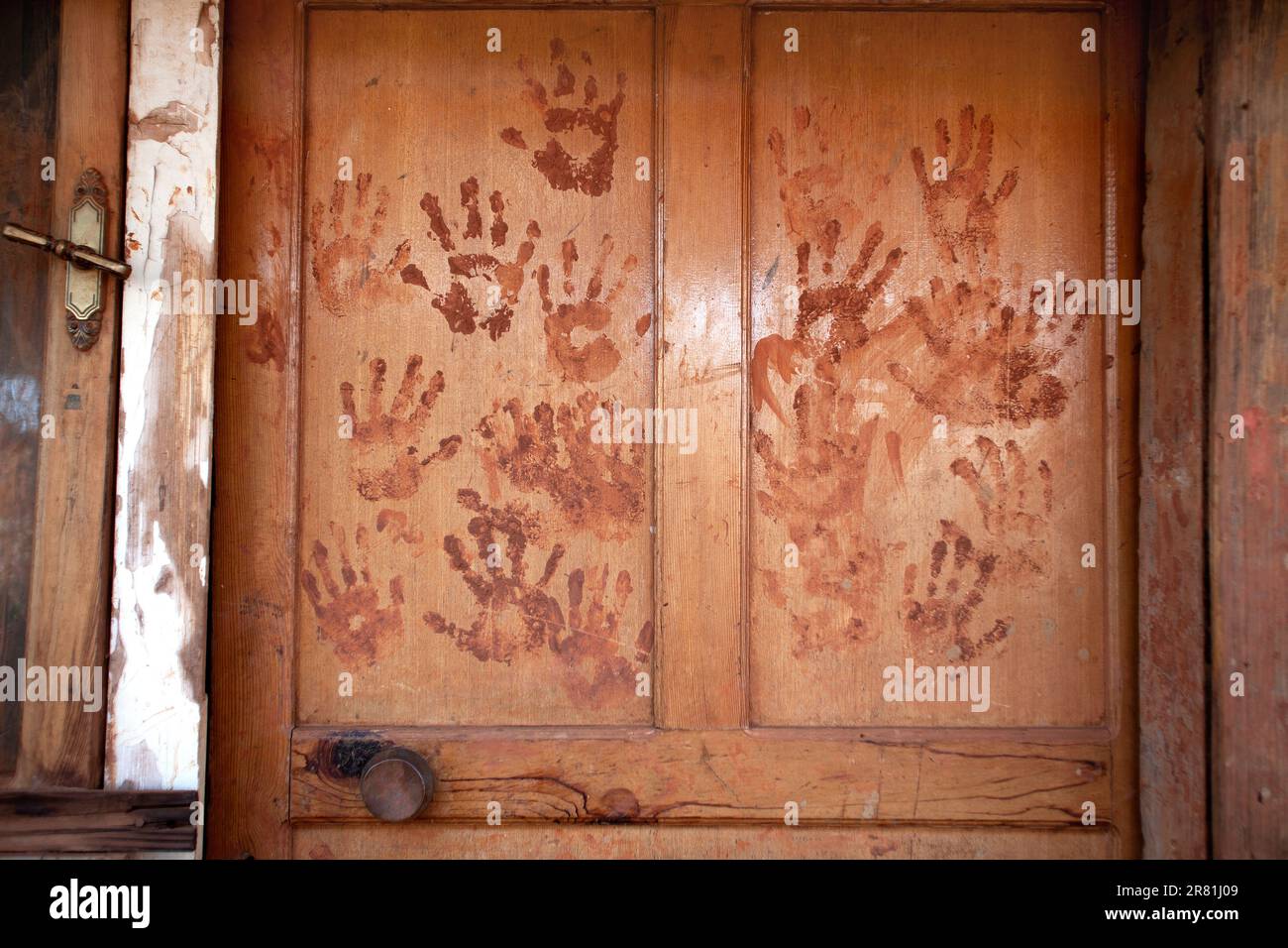 Red handprints on an ancient wooden door Stock Photo - Alamy
