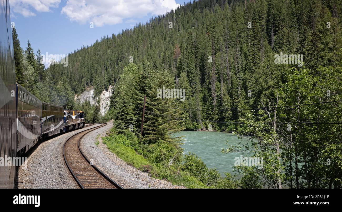 Rocky Mountaineer luxury train rounding bend along the Fraser River in ...