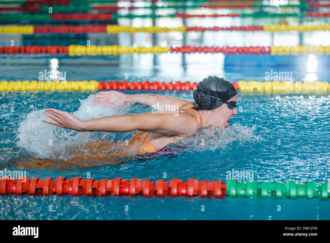 Female competitive swimmer moving through the water performing the ...